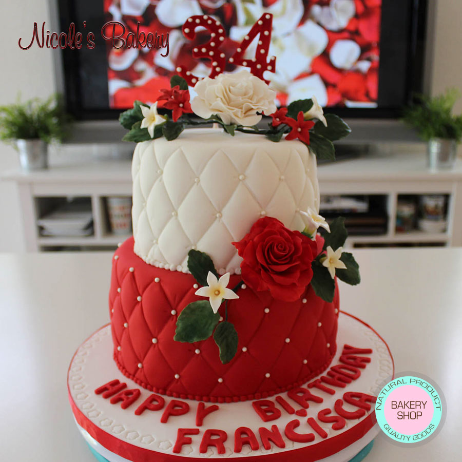 Elegant white and red cake with gum paste roses.