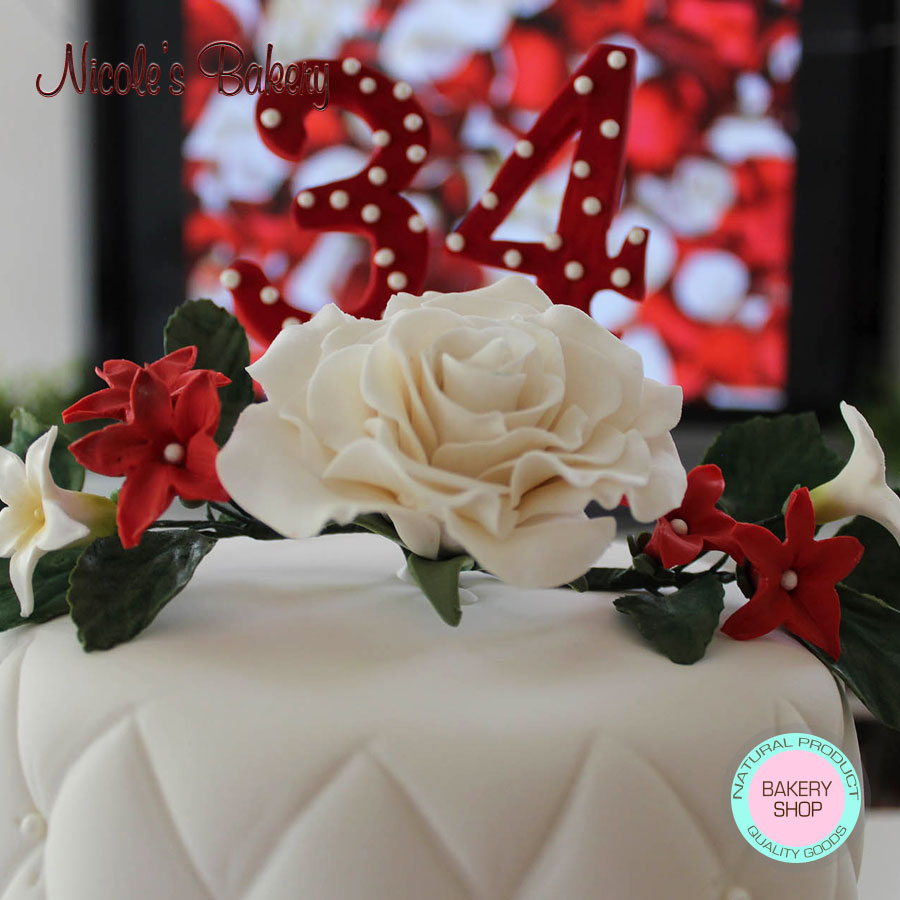 Elegant white and red cake with gum paste roses.