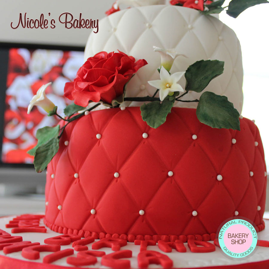 Elegant white and red cake with gum paste roses.